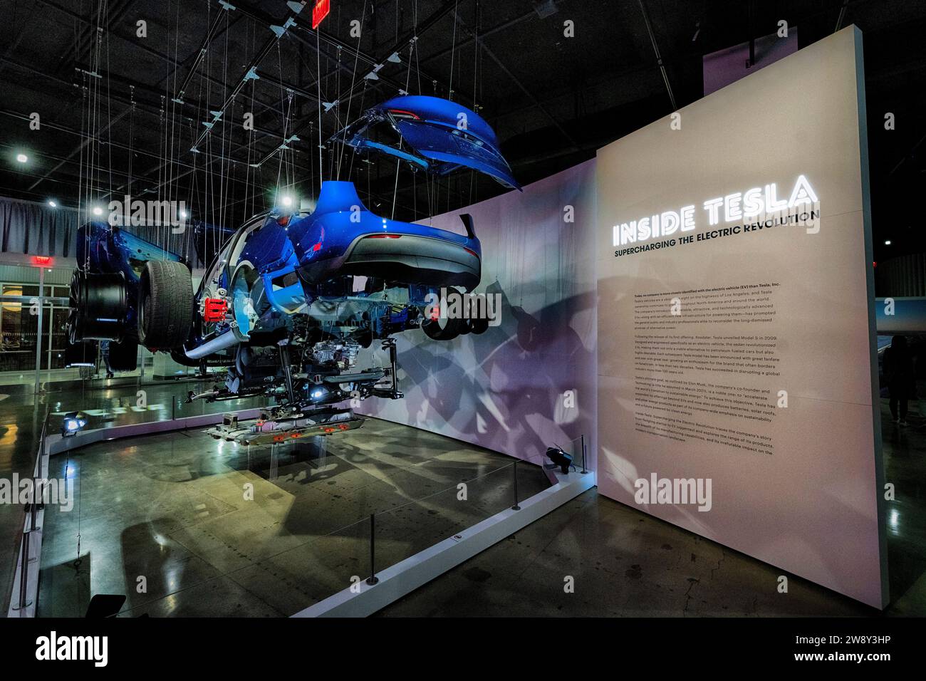 A deconstructed 2022 Tesla Model Y is seen suspended on display at the ...