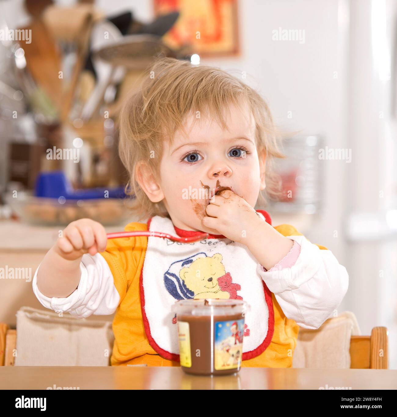 Toddler eats chocolate Stock Photo - Alamy