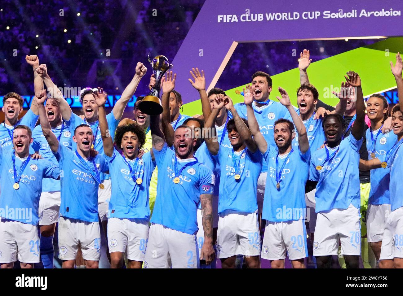 Manchester City's Kyle Walker, center, lifts the trophy at the end of ...