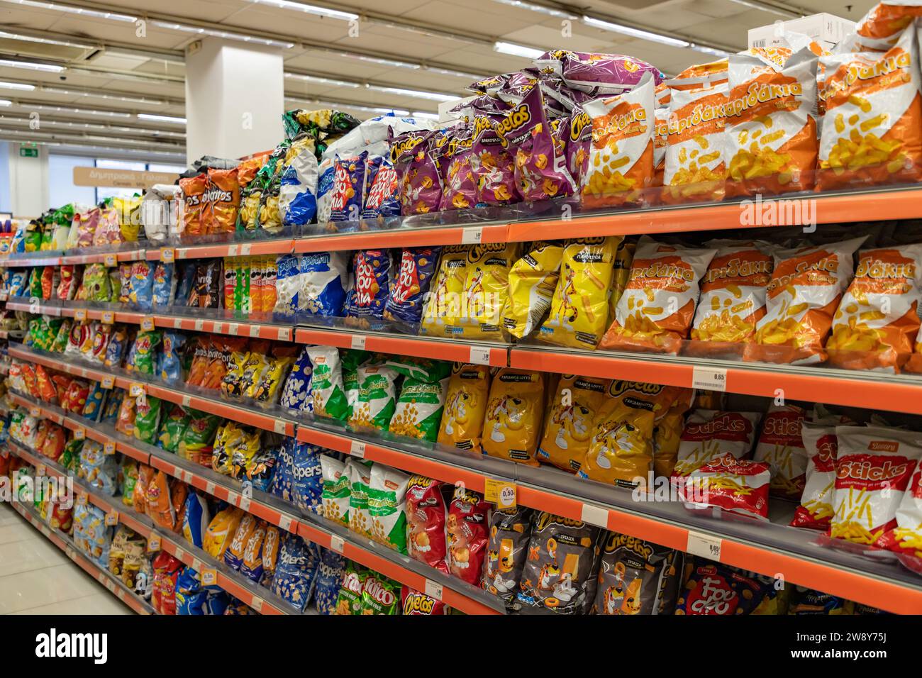 A picture of the snacks and chips section inside a Greek supermarket ...