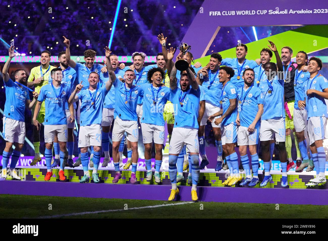 Manchester City's Kyle Walker, center, lifts the trophy at the end of ...