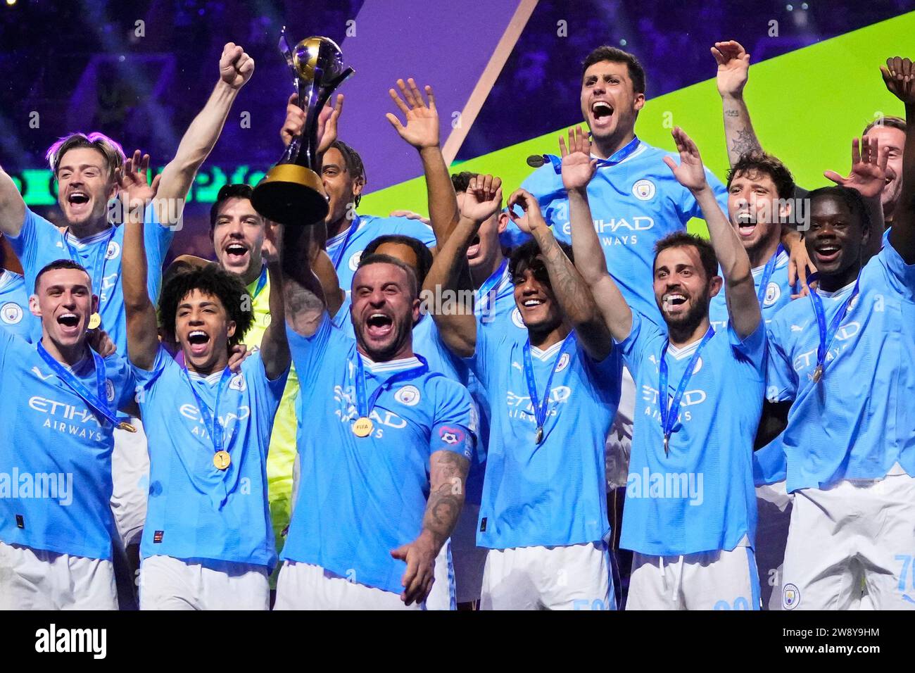 Manchester City's Kyle Walker, center, lifts the trophy at the end of ...