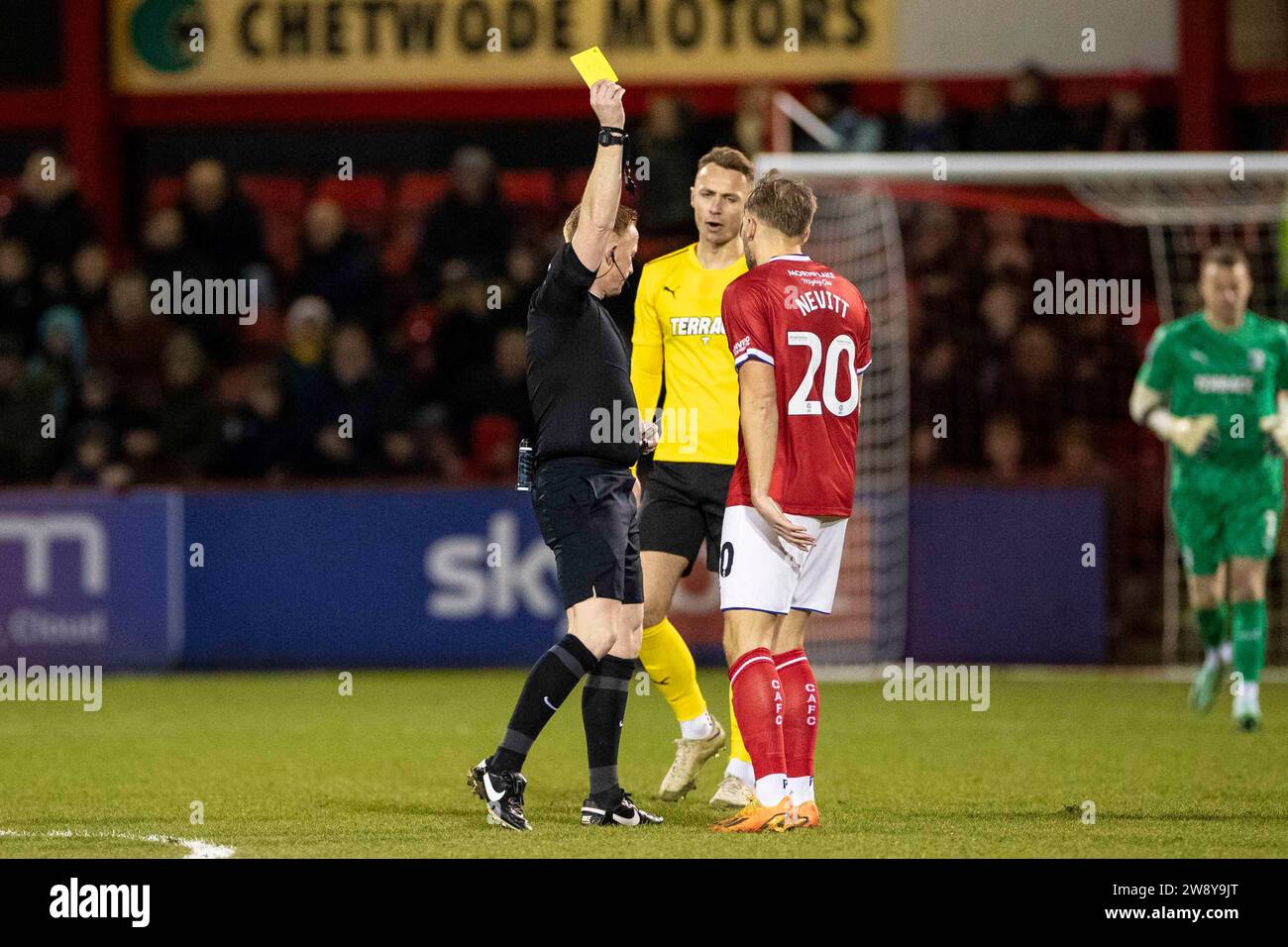 Referee Alan Young shows yellow card toElliott Nevitt #20 of Crewe ...