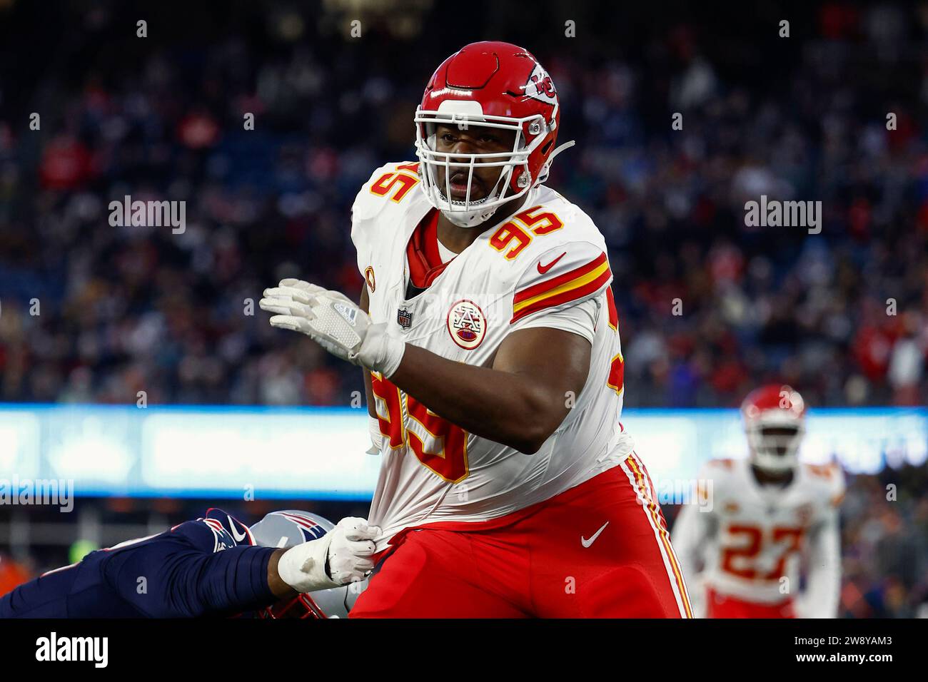 Kansas City Chiefs defensive tackle Chris Jones has his jersey held as ...