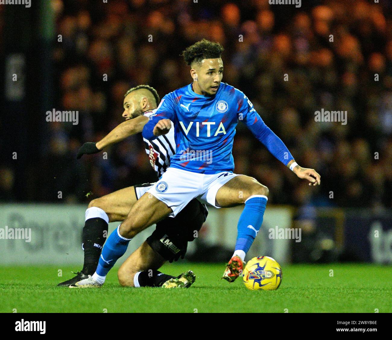 Odin Bailey 27# of Stockport County Football Club holds off a challenge ...