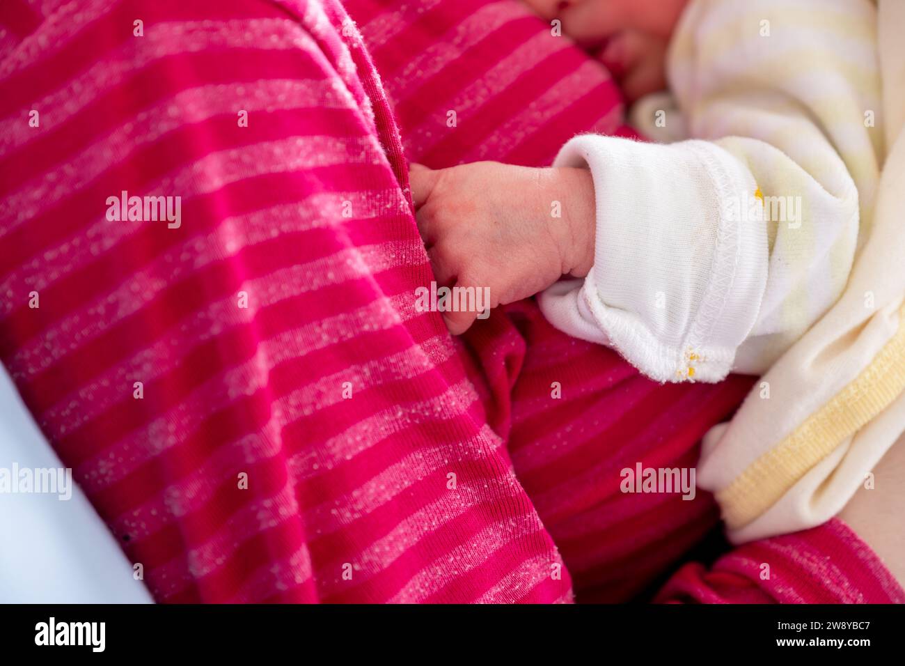 mother cuddling her newborn with smile on their faces and adorable look ...