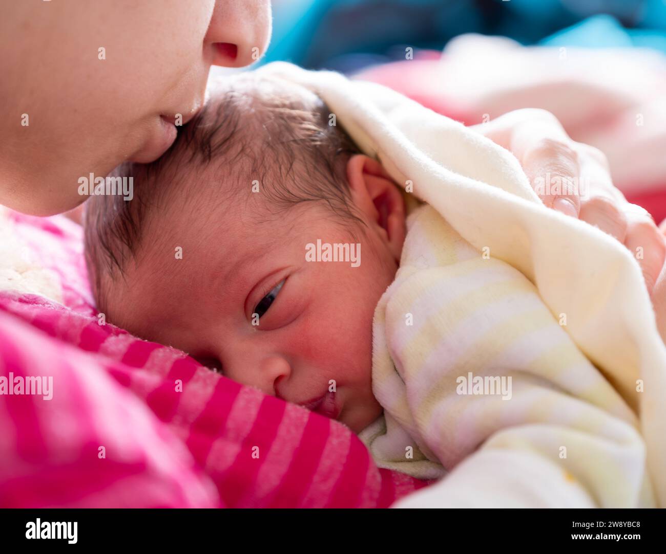 mother cuddling her newborn with smile on their faces and adorable look ...