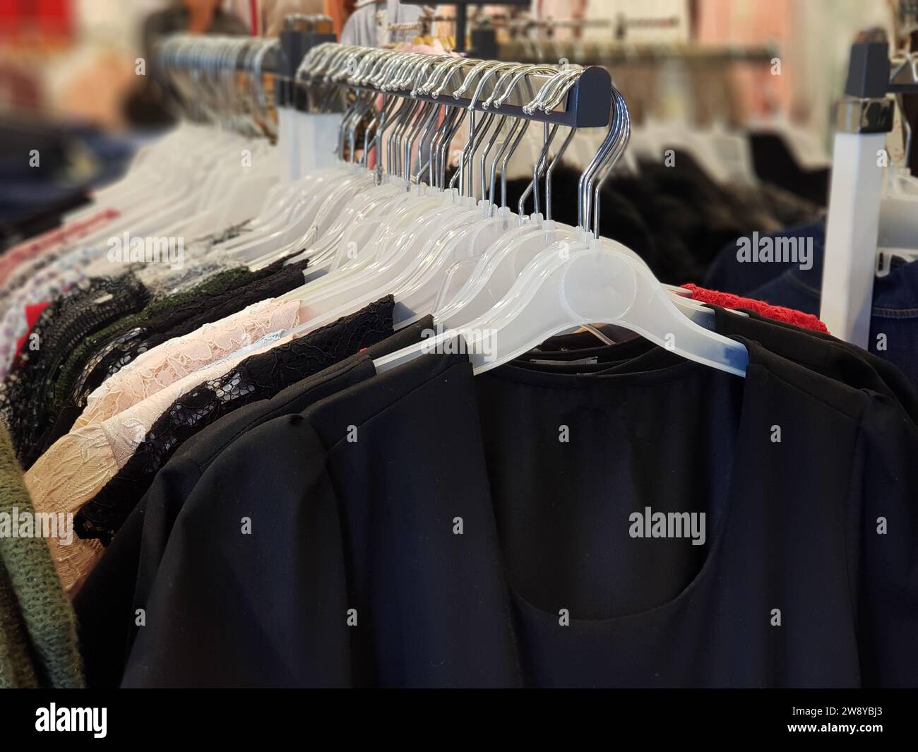 Clothing on hanger at the modern shop boutique Stock Photo - Alamy