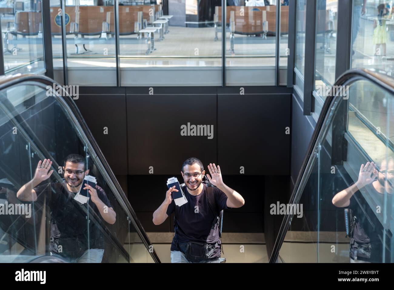 Cheerful male holding his passport after long journey feeling excited ...