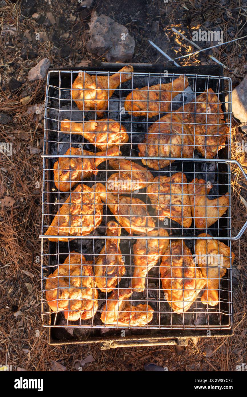 Roasted chickens on spit grilled over fire flame Stock Photo - Alamy
