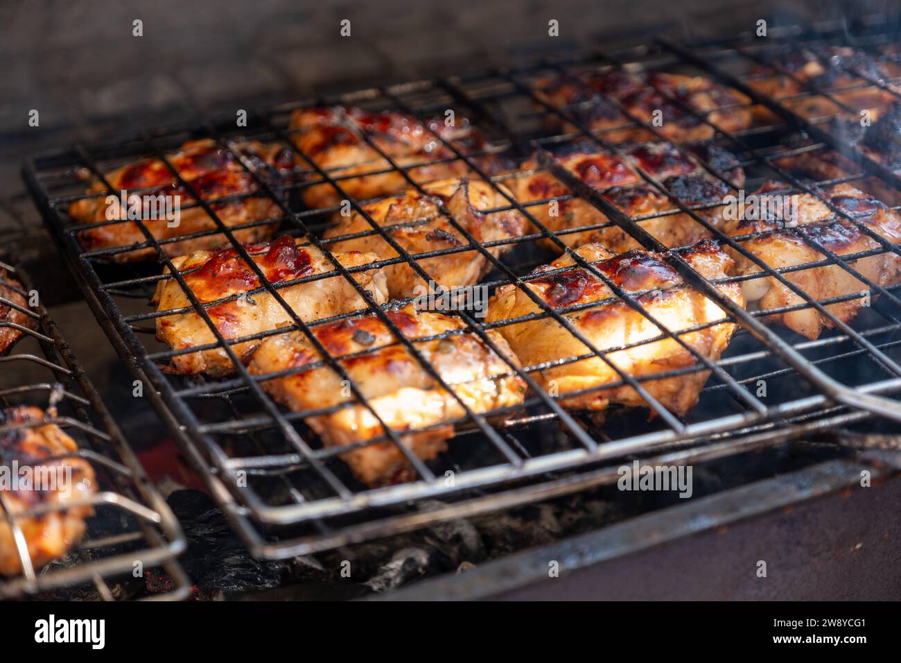 Roasted chickens on spit grilled over fire flame Stock Photo - Alamy