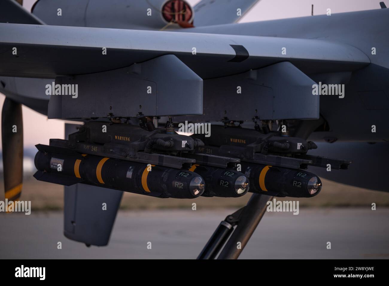 Three AGM-114 Hellfire missiles attached to the MQ-9 Reaper Aircraft ...