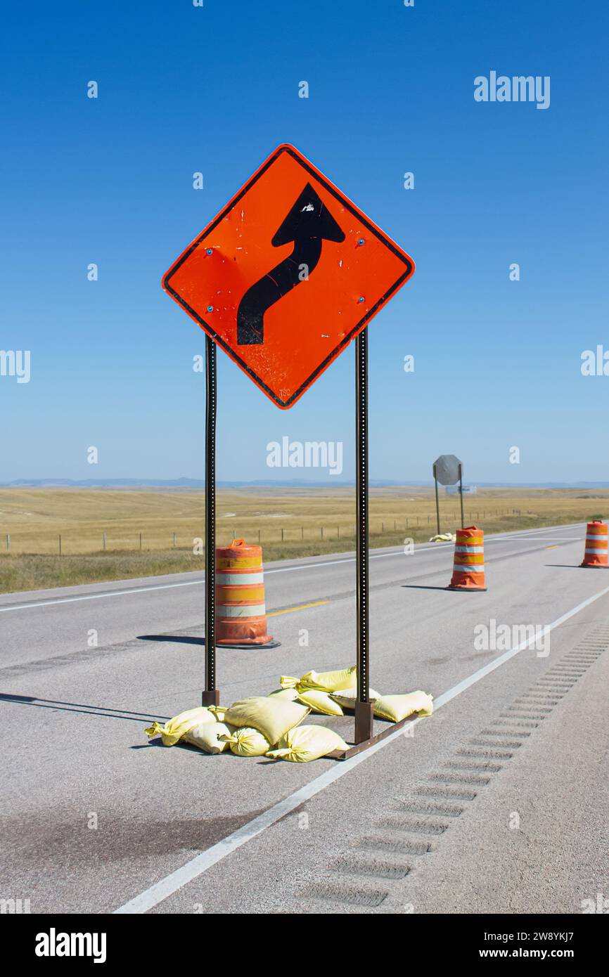 Traffic winding road sign on the road with nobody around. Safety ...