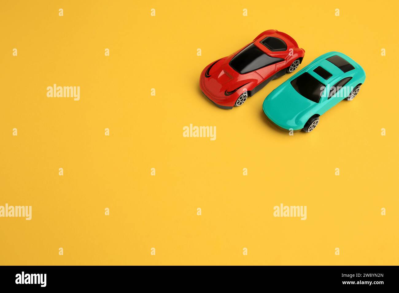 Bright cars on yellow background, space for text. Children`s toys Stock ...