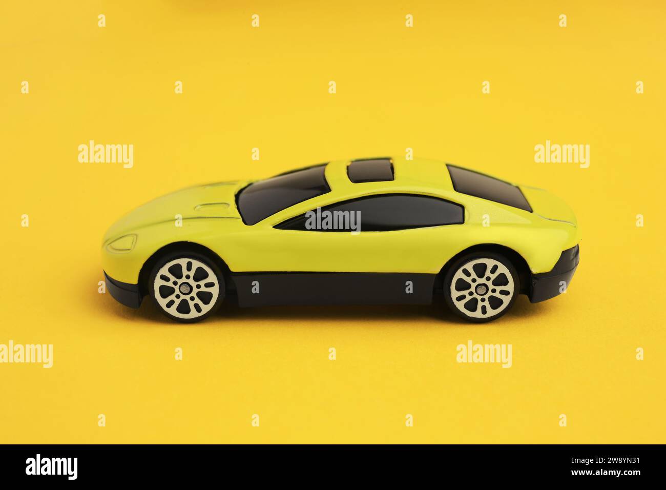 One bright car on yellow background. Children`s toy Stock Photo - Alamy