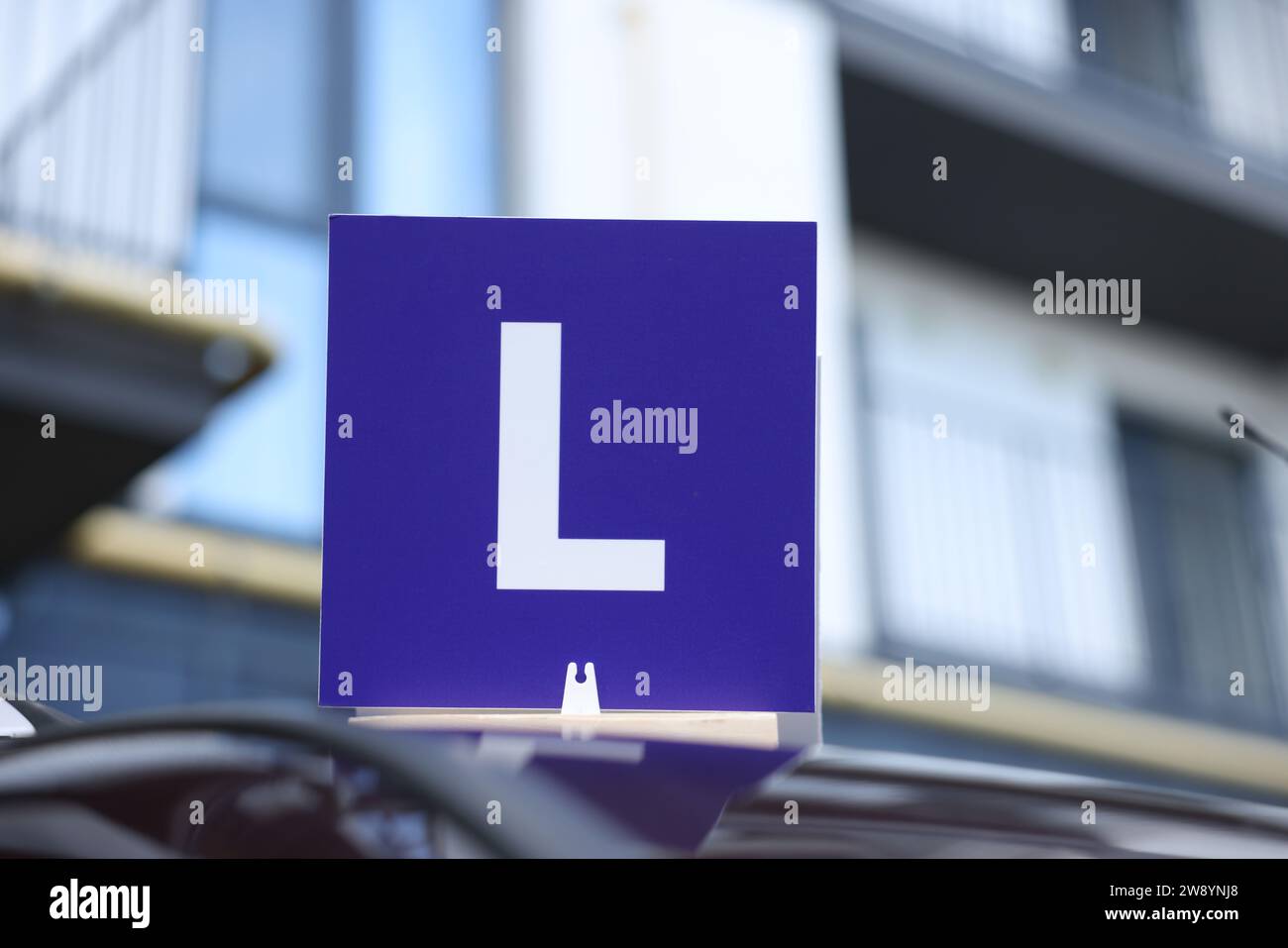 L-plate on car roof outdoors. Driving school Stock Photo - Alamy