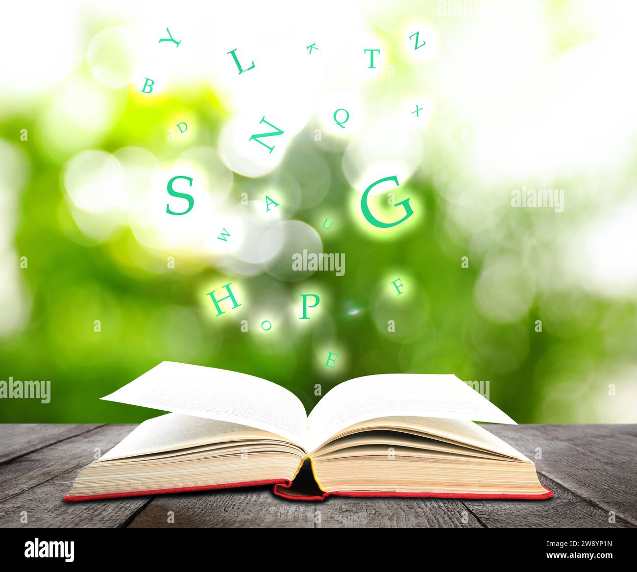 Open book with letters flying out of it on wooden table against blurred ...