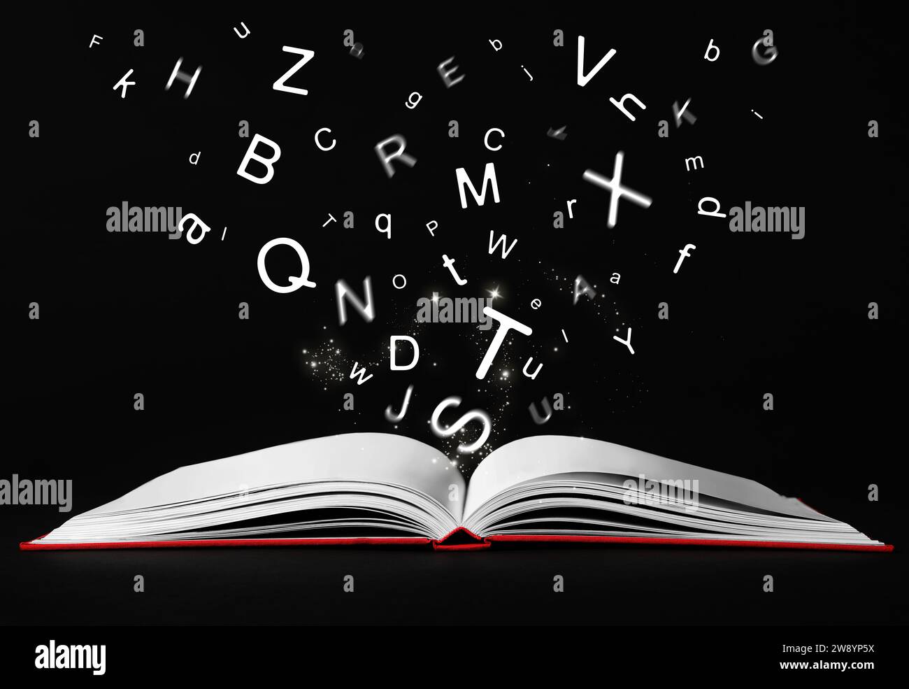 Letters flying out from open book on black background Stock Photo - Alamy