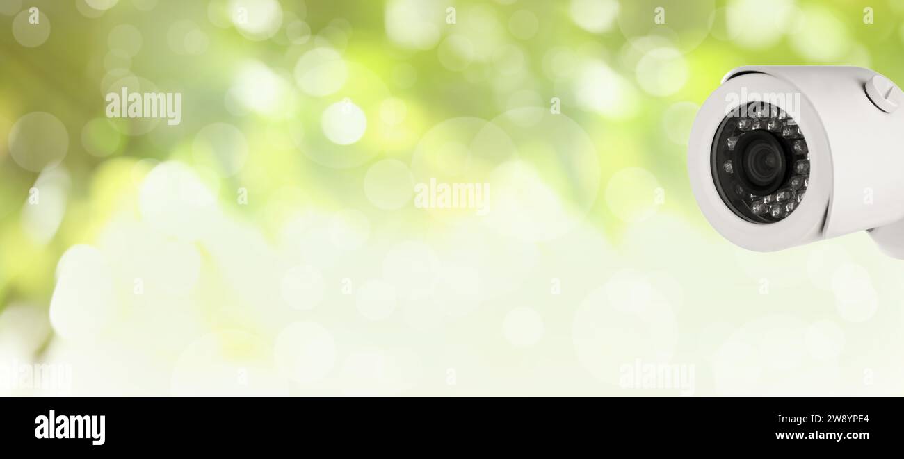 Modern security CCTV camera outdoors, space for text. Banner design ...
