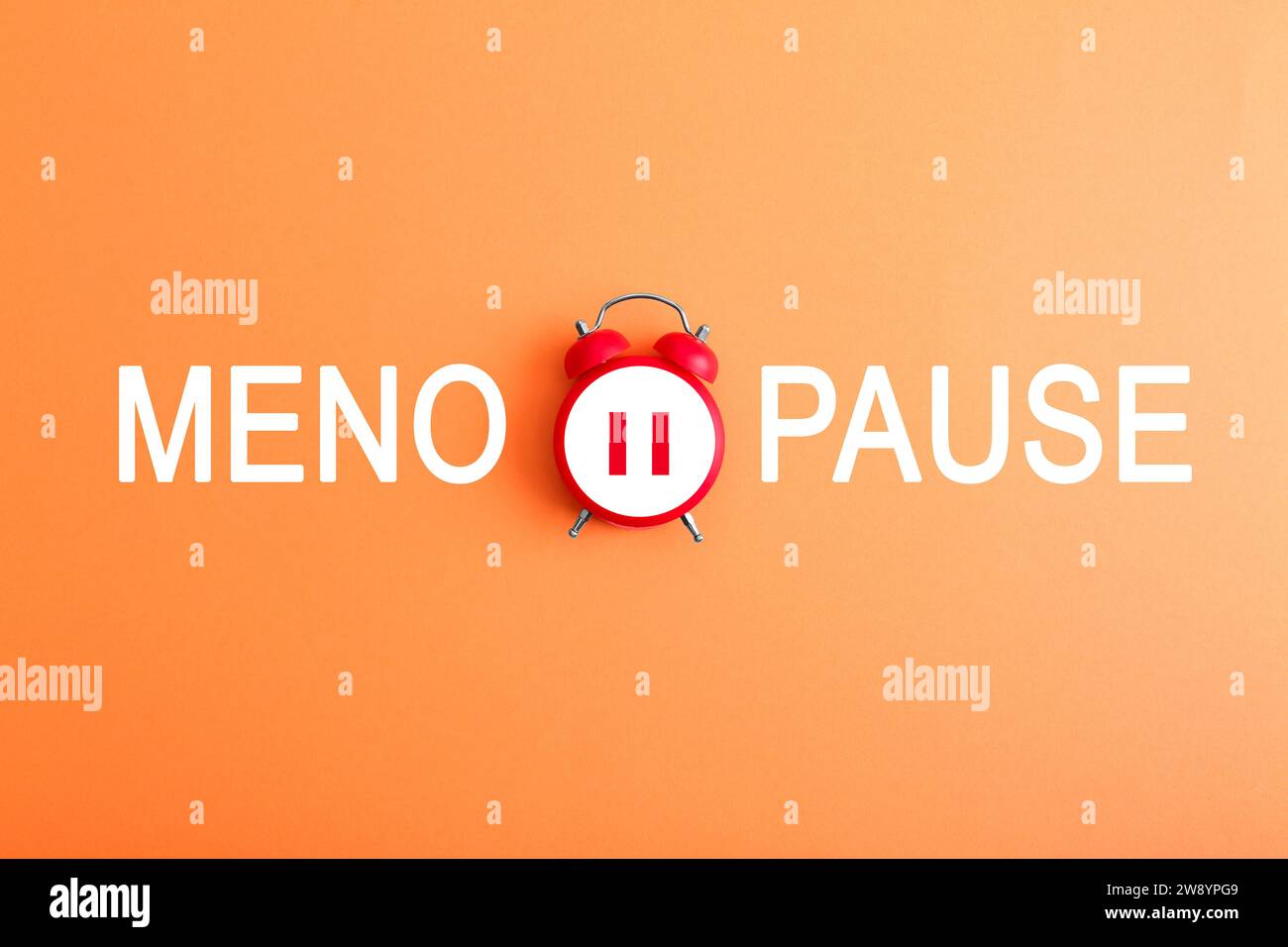 Menopause word and alarm clock with pause symbol on orange background ...