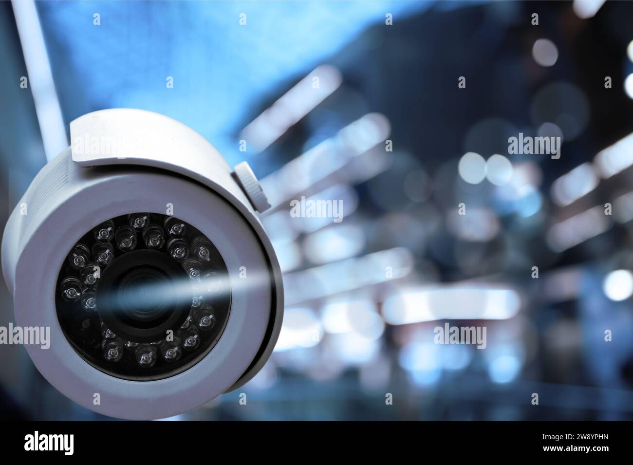 Modern security CCTV camera against blurred background, space for text ...