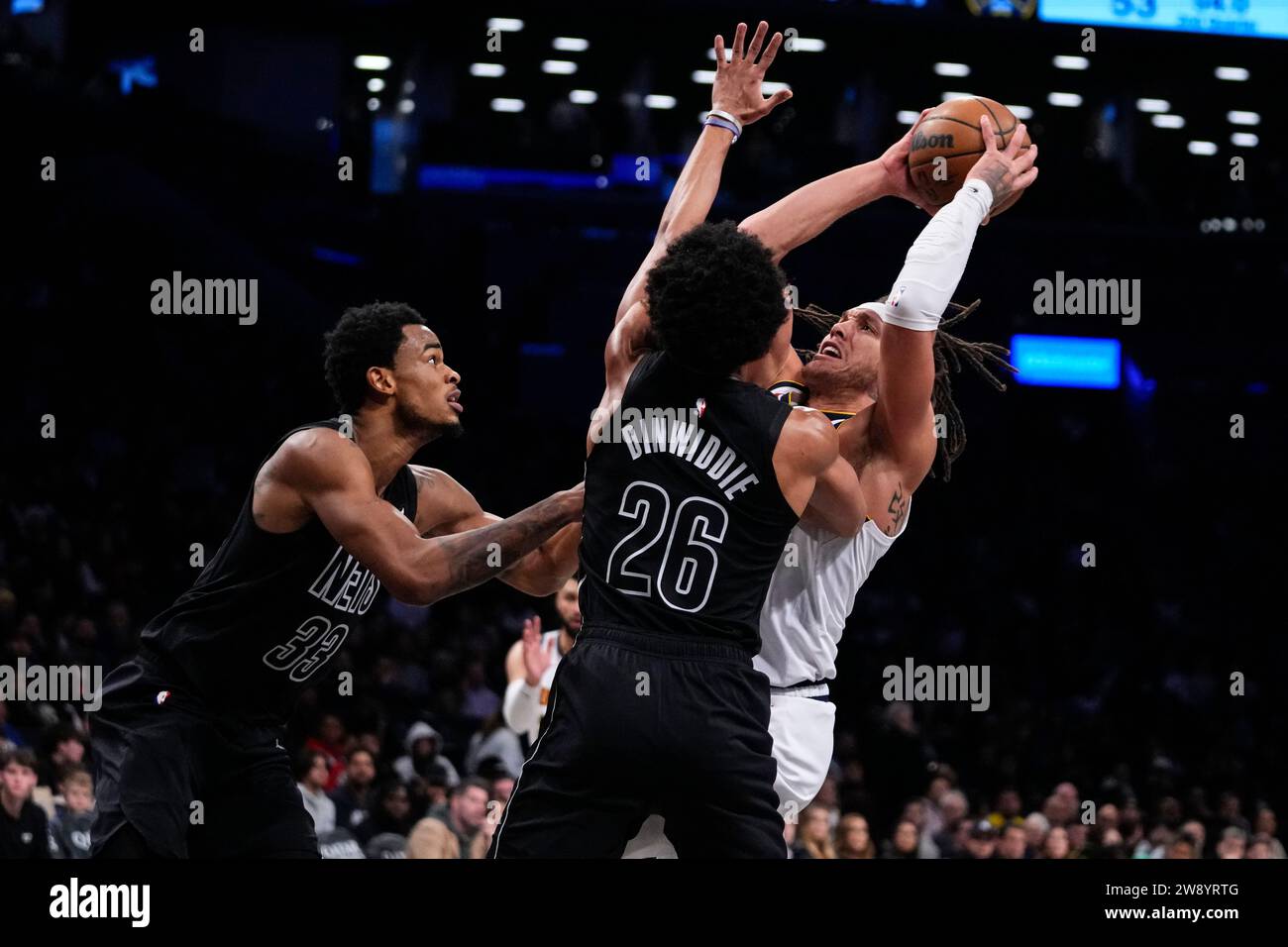 Denver Nuggets' Aaron Gordon, right, shoots over Brooklyn Nets' Spencer ...