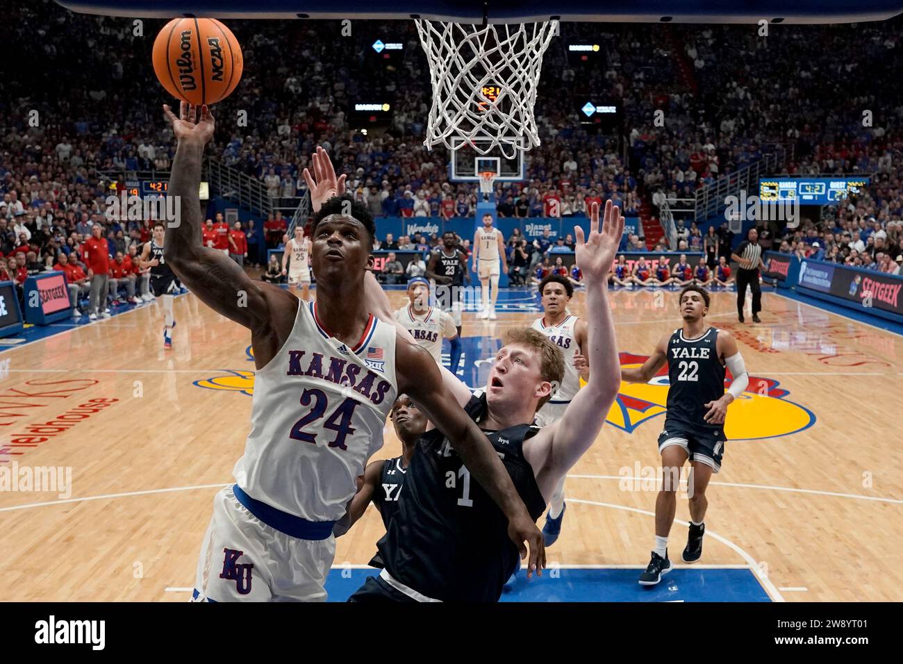 Kansas forward K.J. Adams Jr. (24) gets past Yale forward Danny Wolf (1 ...
