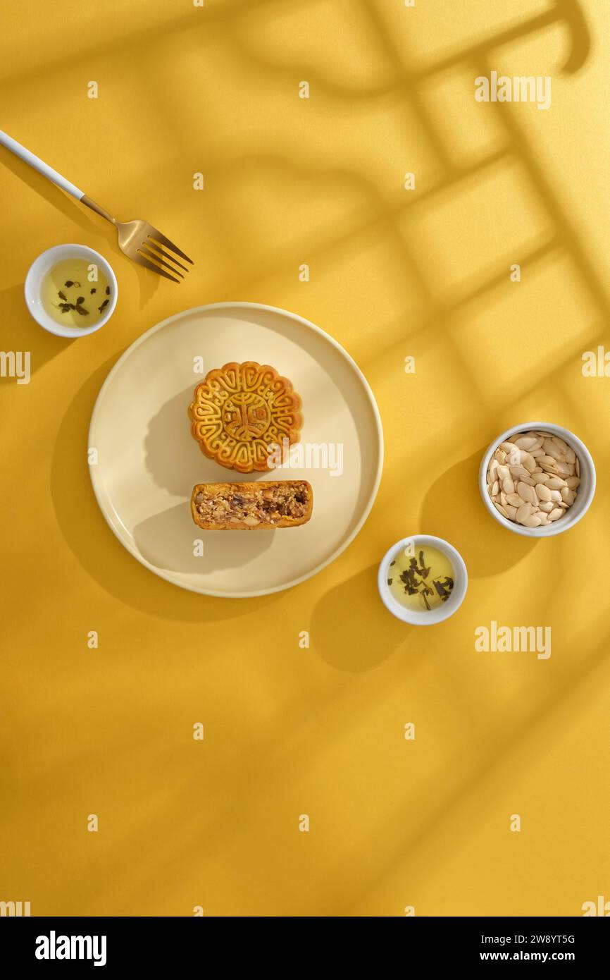 On a ceramic dish, delicious mooncakes displayed with tea cups and ...