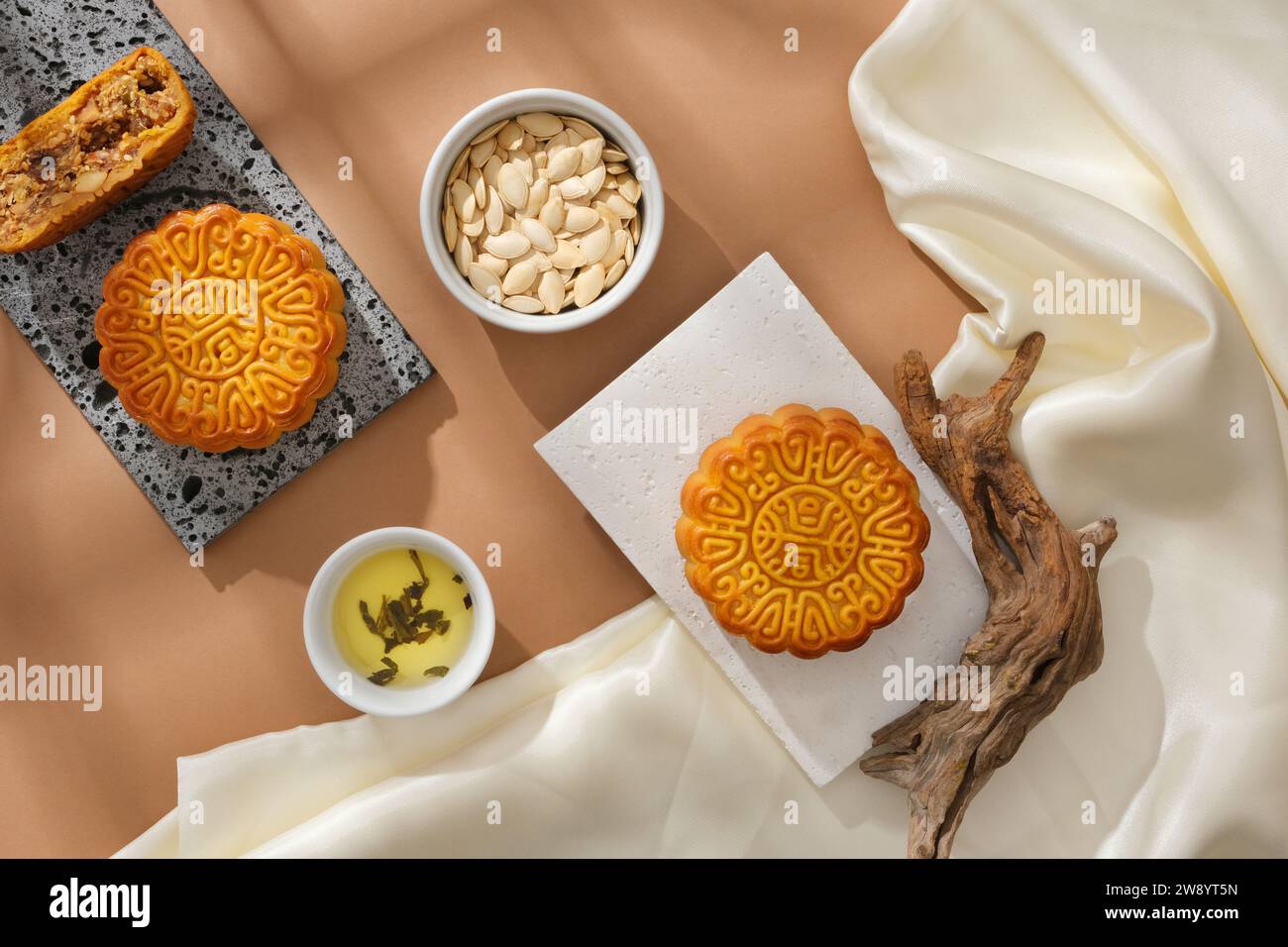 Holiday concept of Mid-Autumn festival traditional food design. Mooncakes displayed on brick ...