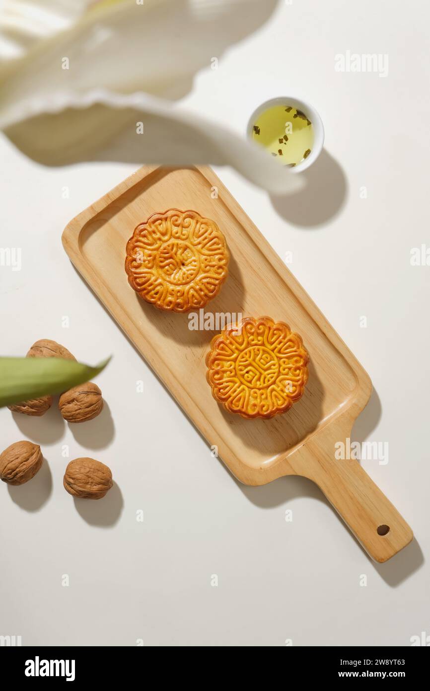 Overhead view of delicious mooncakes on a wooden trays with tea cup and ...
