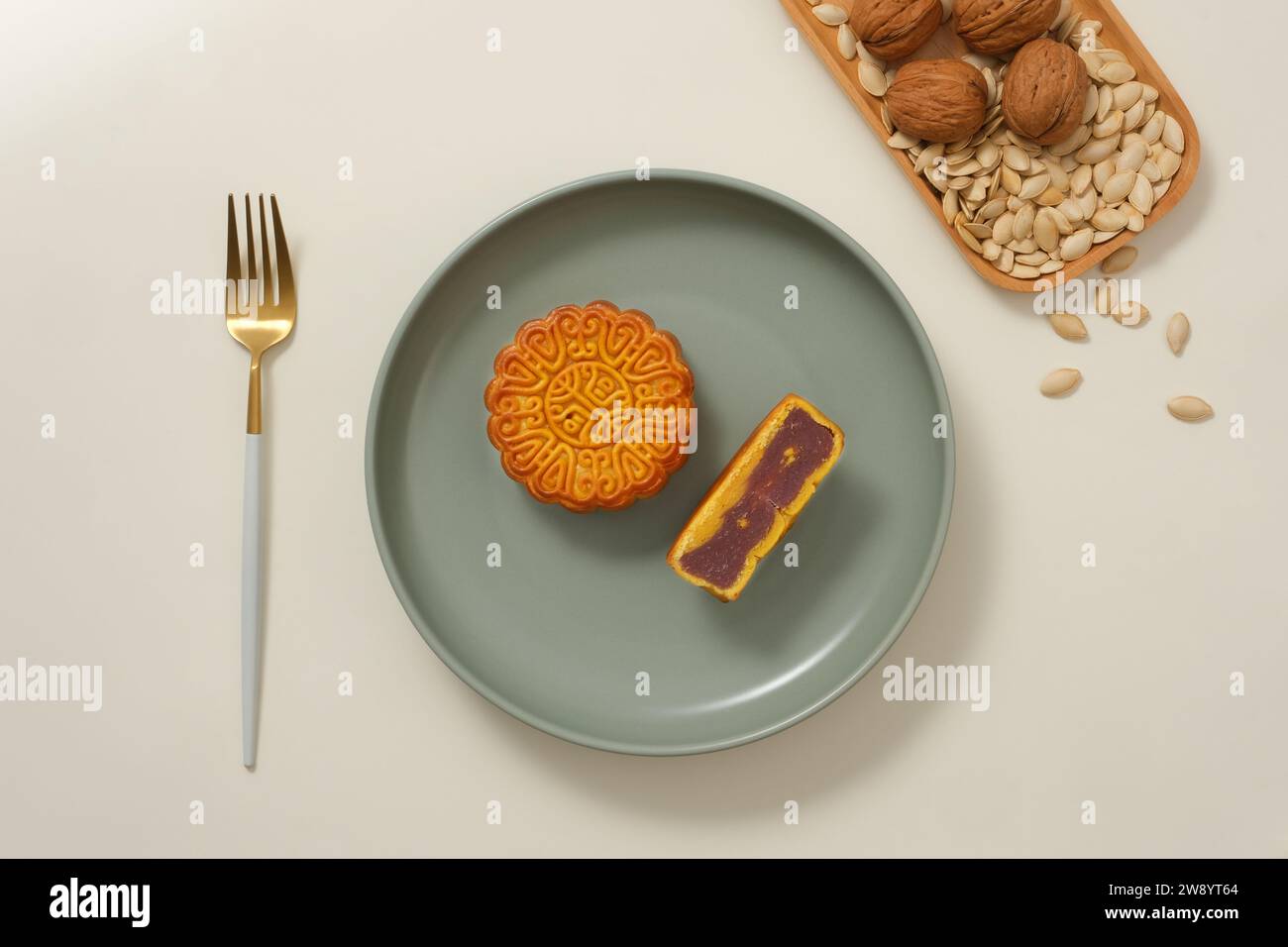 A round ceramic dish of delicious mooncakes decorated with wooden tray ...