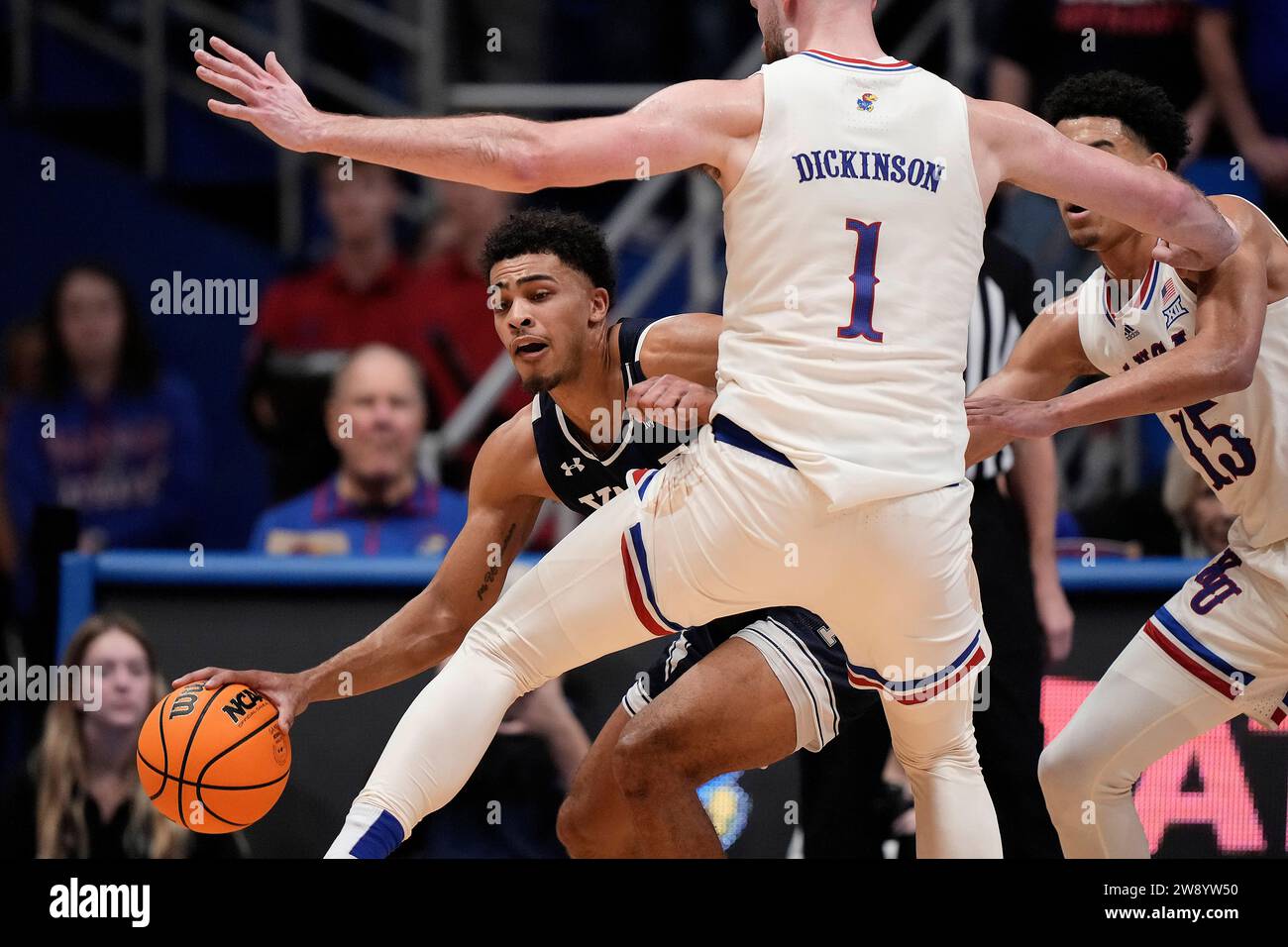 Yale forward Matt Knowling looks to pass around Kansas center Hunter ...