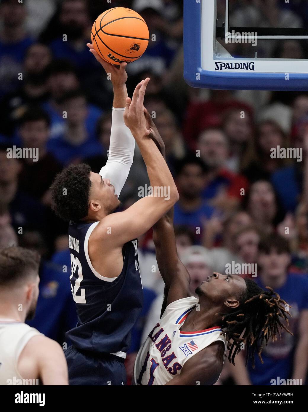 Yale forward Matt Knowling (22) shoots under pressure from Kansas guard ...