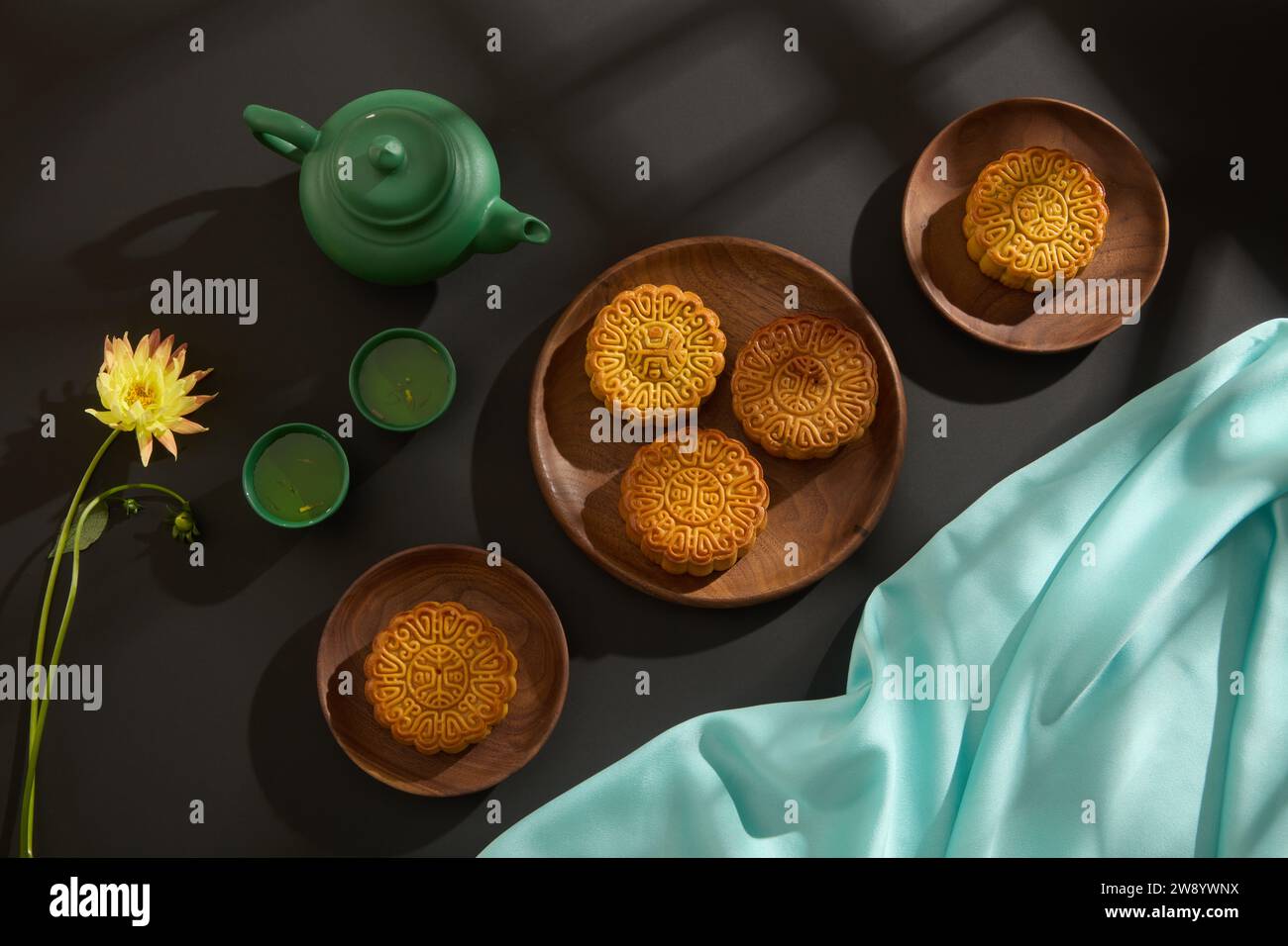 Overhead view of wooden dishes containing mooncakes decorated with ...