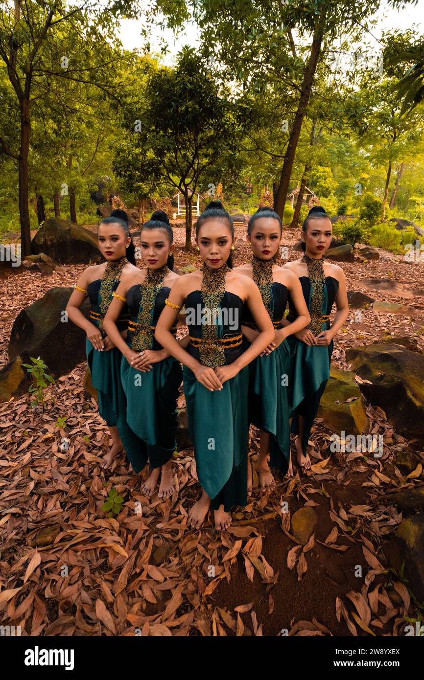 Glamor Asian women with green costumes and makeup line up together in ...