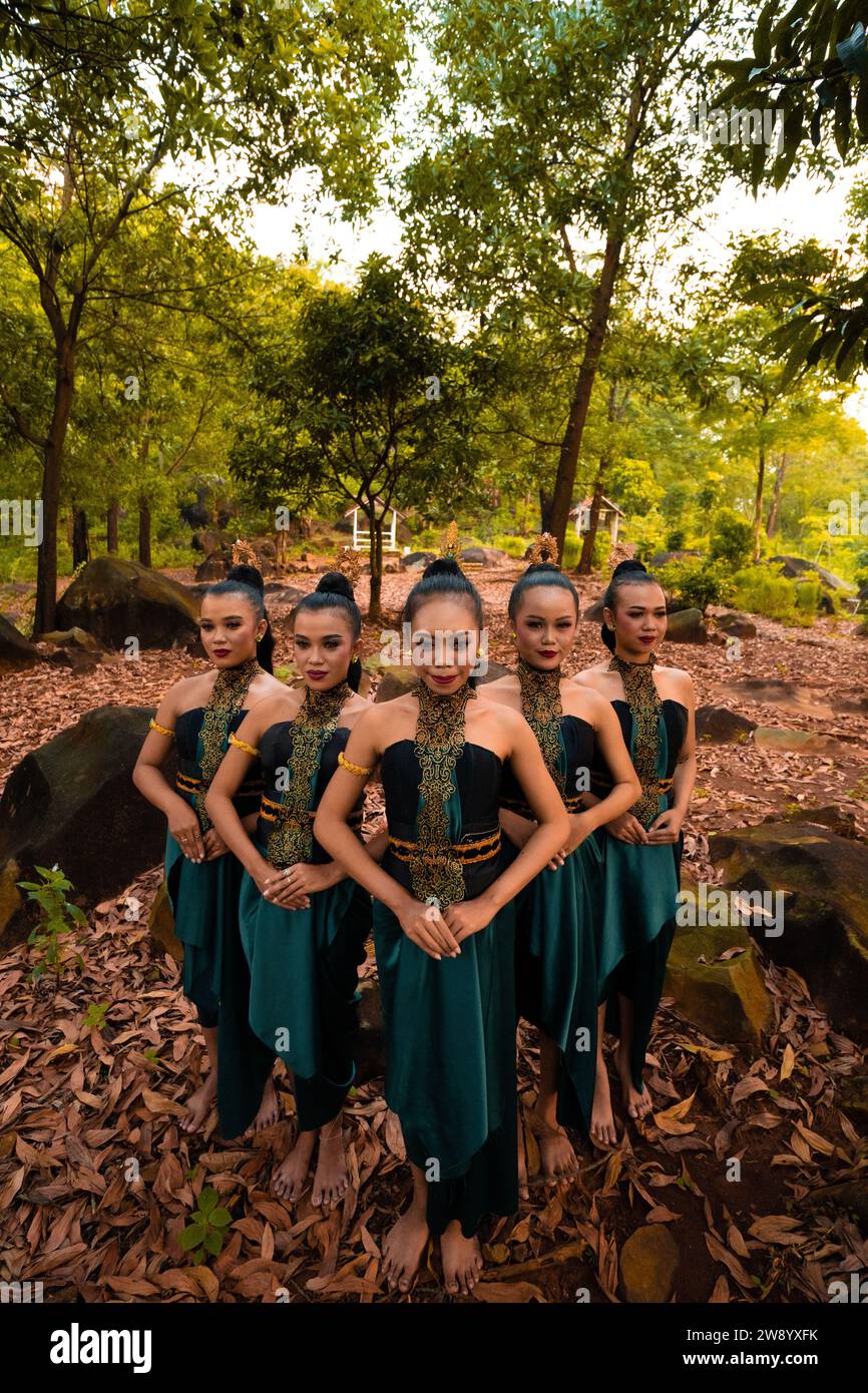 Glamor Asian women with green costumes and makeup line up together in ...