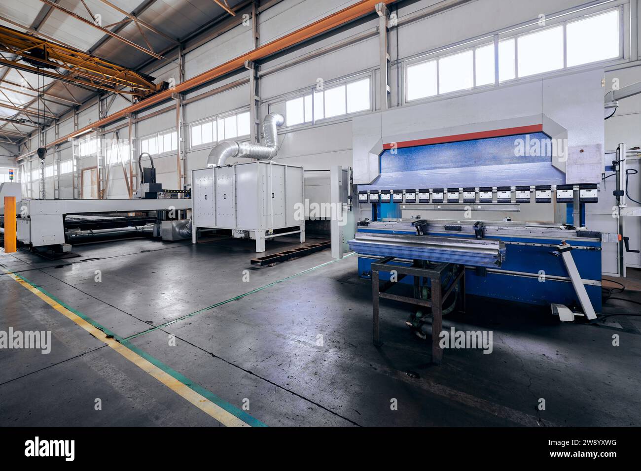 Powerful bending press to process metal sheets at plant Stock Photo - Alamy