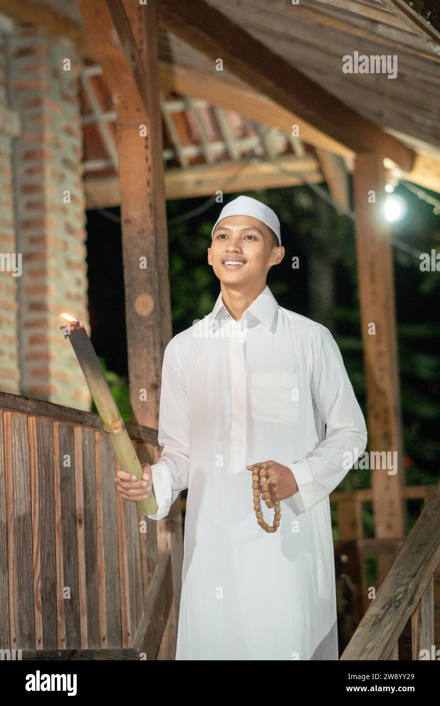 Handsome Islamic man with white Muslim dress in the dark night at the ...