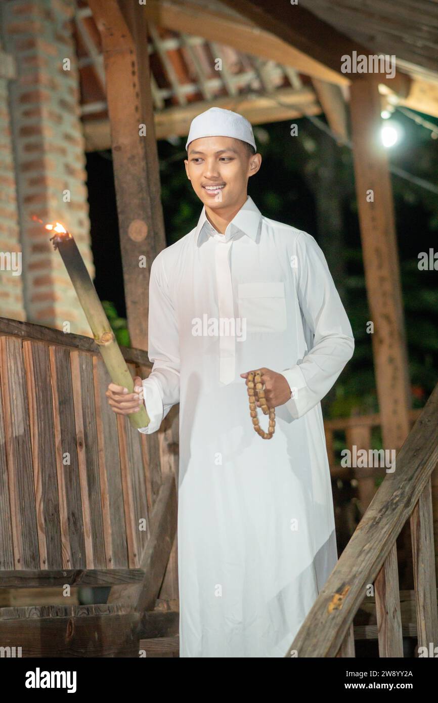 Handsome Islamic man with white Muslim dress in the dark night at the ...