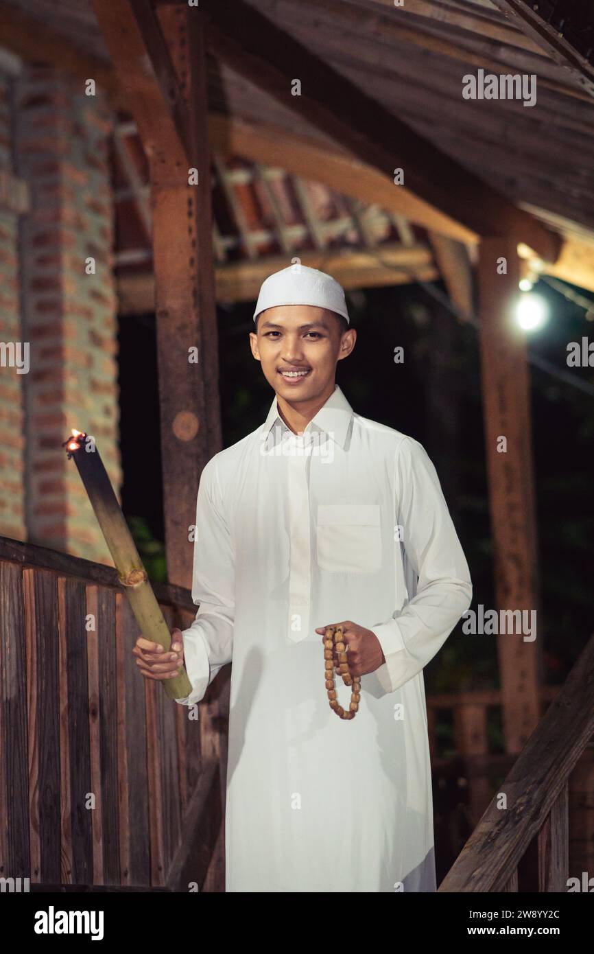 Handsome Islamic man with white Muslim dress in the dark night at the ...