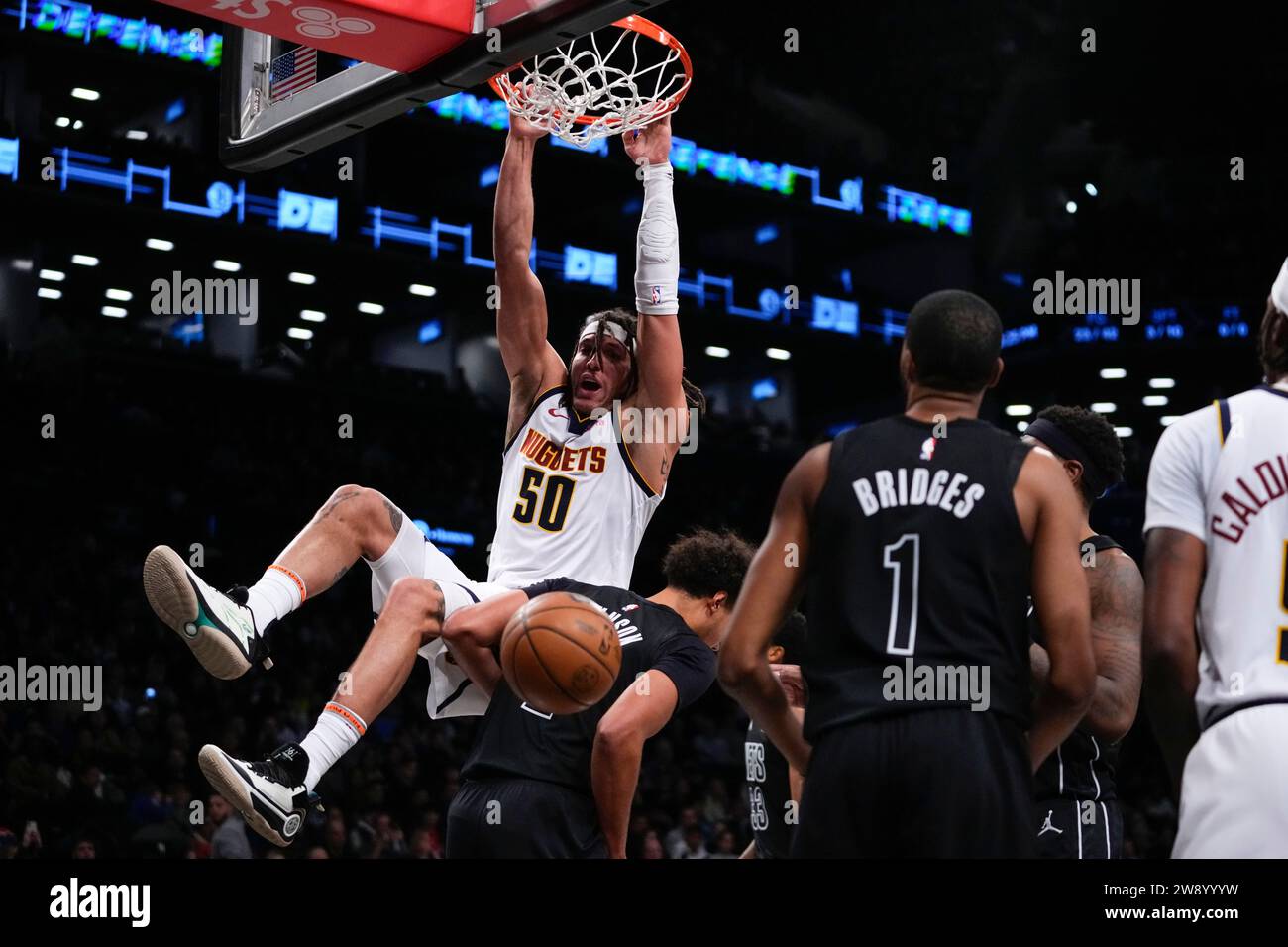 Denver Nuggets' Aaron Gordon (50) dunks the ball in front of Brooklyn Nets' Cameron Johnson and ...