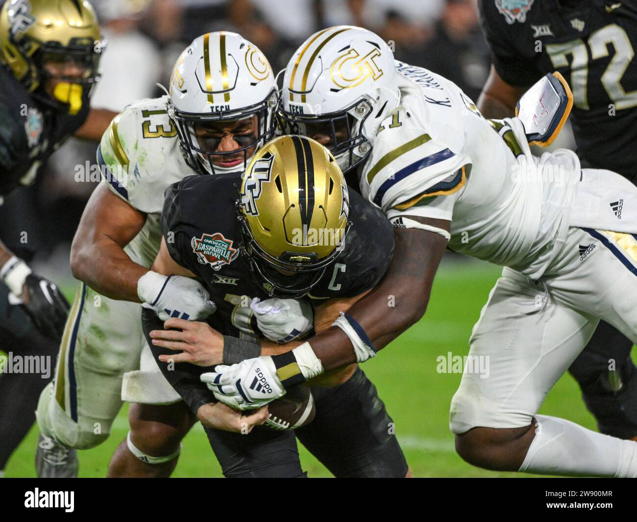 December 22, 2023: UCF quarterback John Rhys Plumlee (10) gets sacked ...