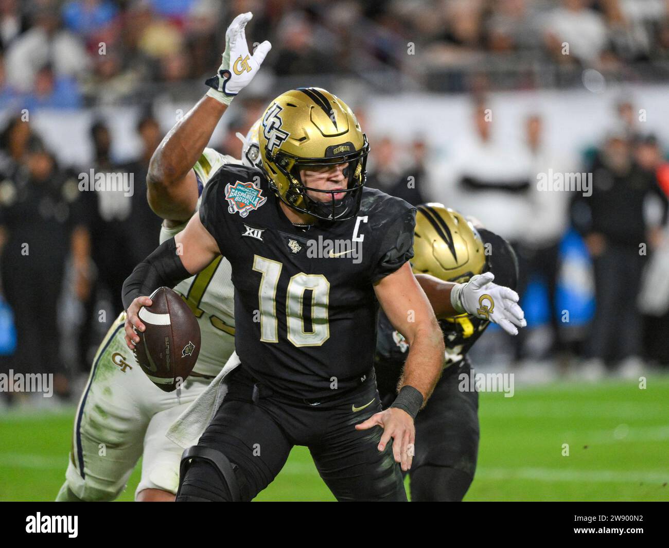 December 22, 2023: UCF quarterback John Rhys Plumlee (10) gets sacked ...