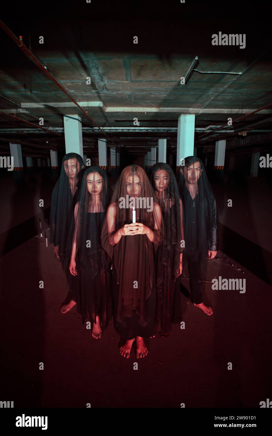 a group of devil worshipers in all black clothes and transparent veils ...