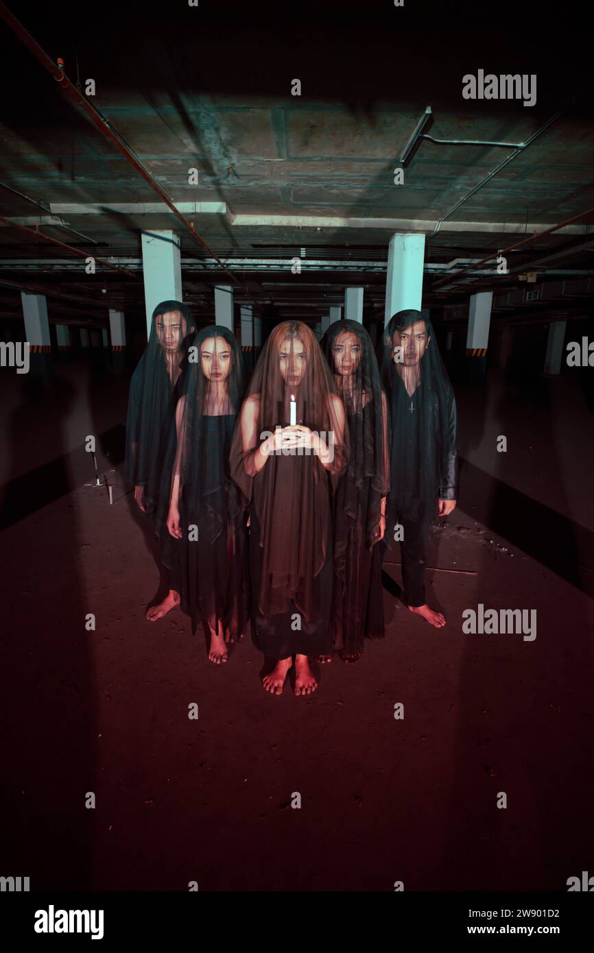 a group of devil worshipers in all black clothes and transparent veils ...