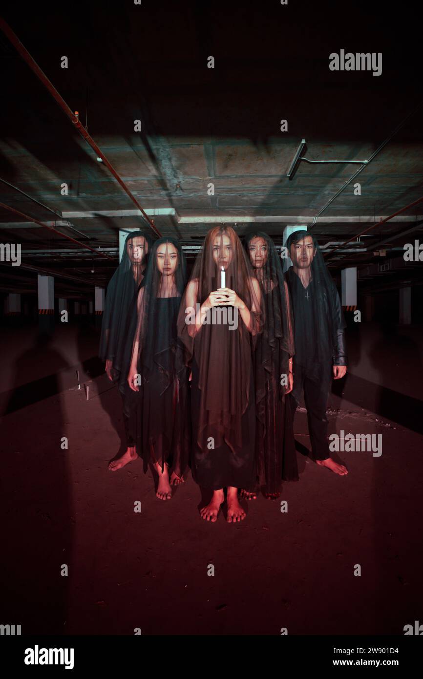 a group of devil worshipers in all black clothes and transparent veils ...