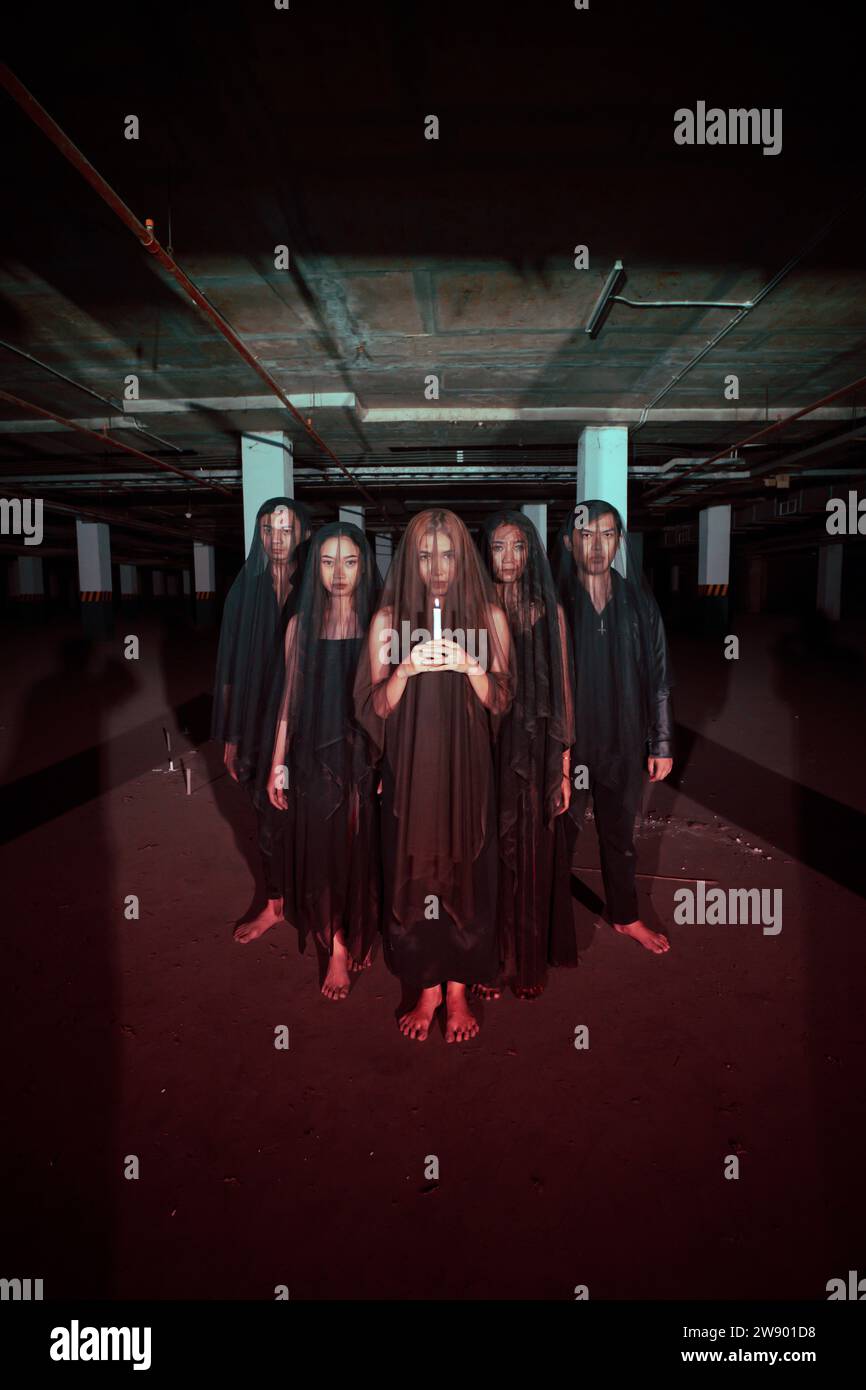 a group of devil worshipers in all black clothes and transparent veils ...