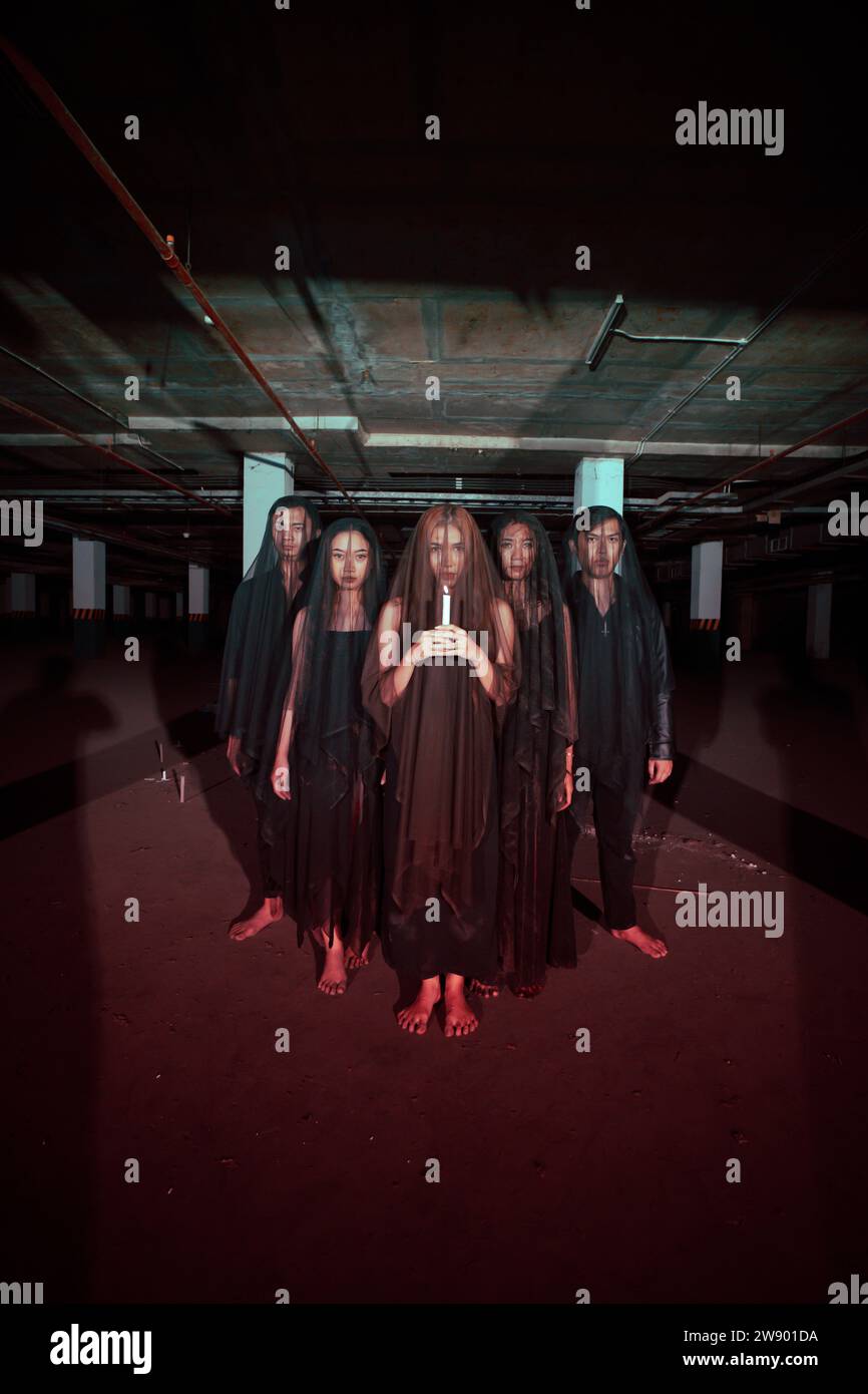 a group of devil worshipers in all black clothes and transparent veils ...