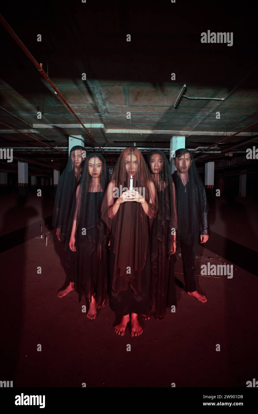 a group of devil worshipers in all black clothes and transparent veils ...