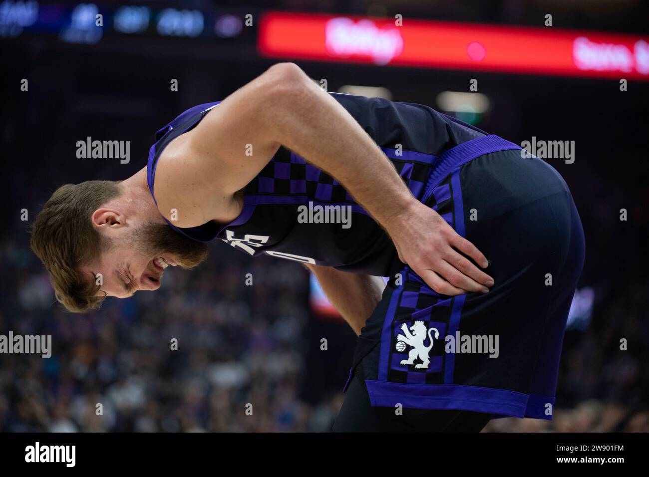 Sacramento Kings forward Domantas Sabonis (10) reacts after taking a knee to his hip during the ...